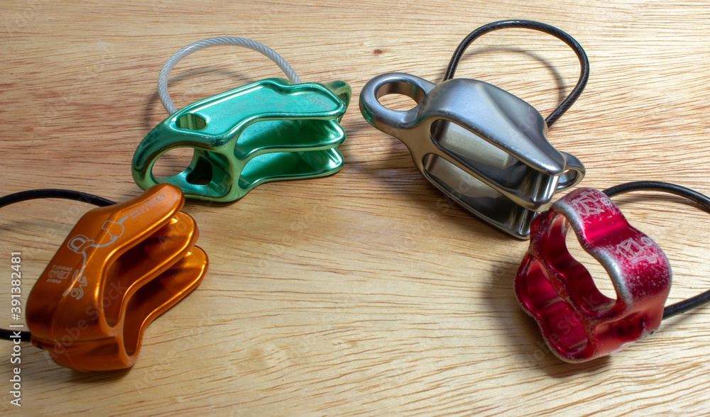 Four belay devices, two of them with guide mode function Stock Photo ...