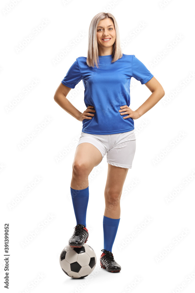 Full length portrait of a female football player posing with a soccer ...