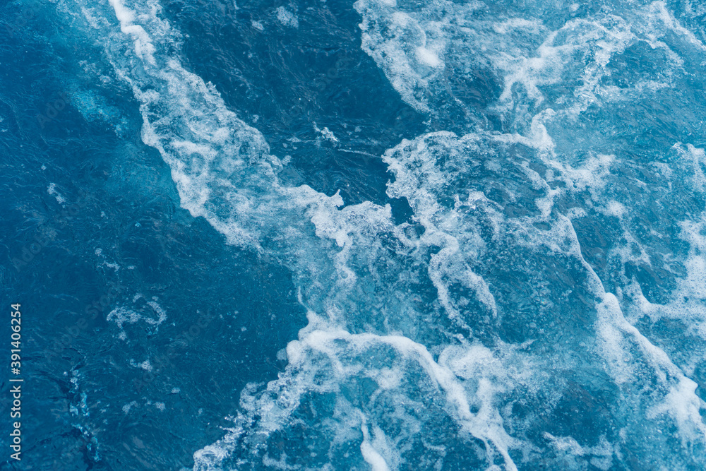 Deep blue stormy ocean water with splashes and foam, top view. Natural ...