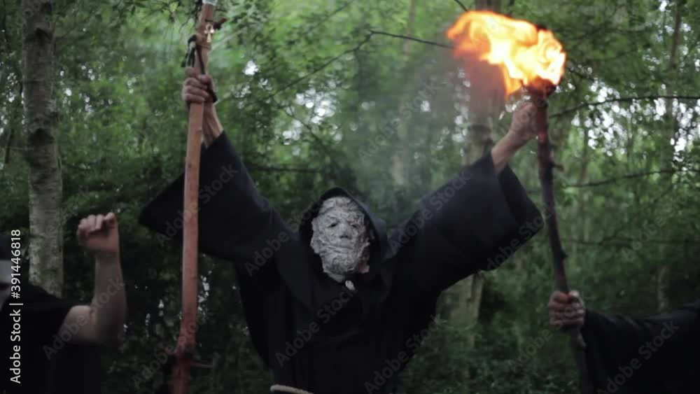 A pagan cult grand master leads his evil druid followers in a ritual of ...