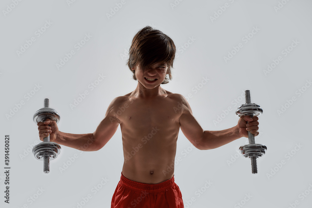 Little sportive boy child with muscular body looking emotional while ...
