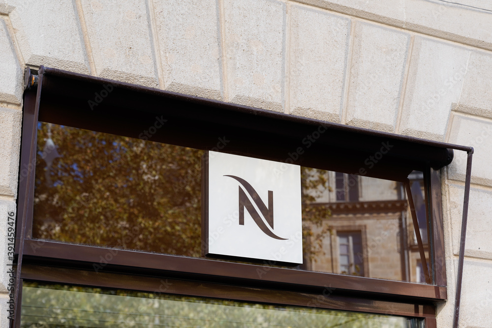 Nespresso logo sign front of shop coffee machines capsules and ...