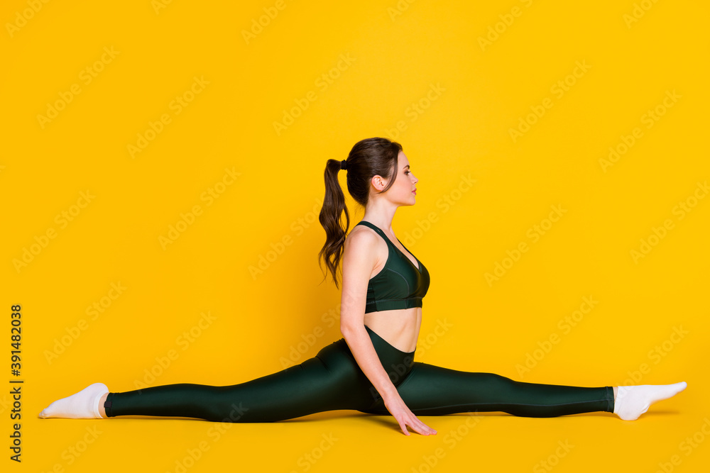 Full length profile photo of sportive lady sitting floor stretch legs ...