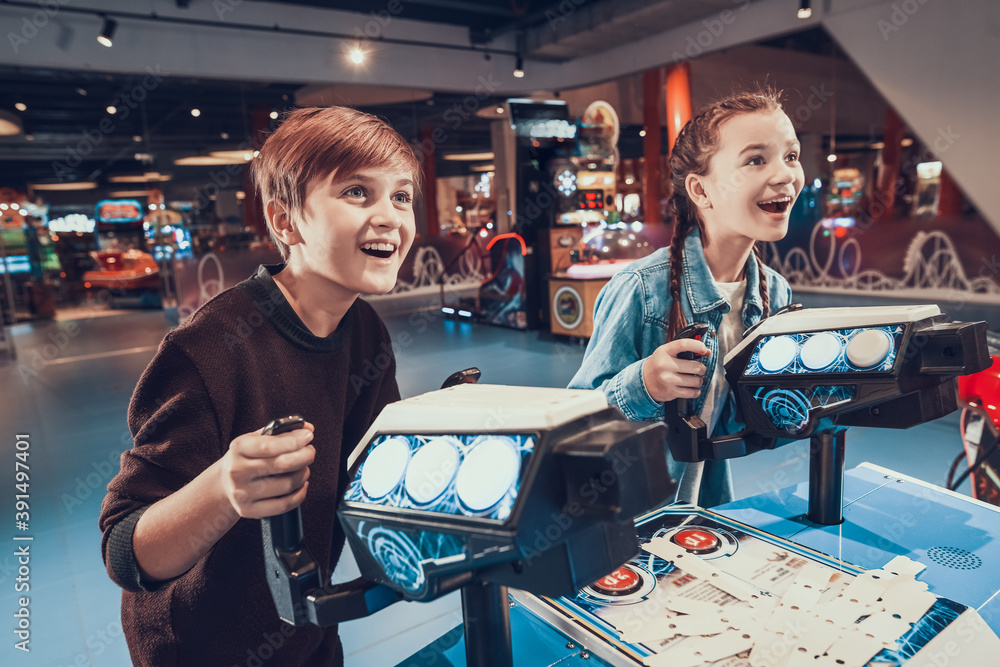 Brother and sister have fun while playing games. Stock Photo | Adobe Stock