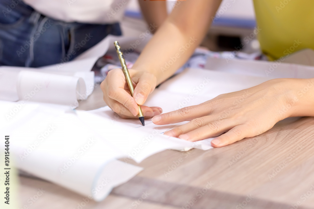 Fashion designer's hands. Closeup of hands drafting a new sewing ...