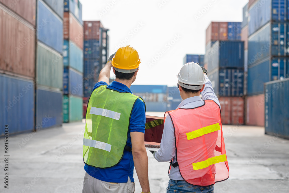 Two Foreman with laptop checking position loading Containers box from ...