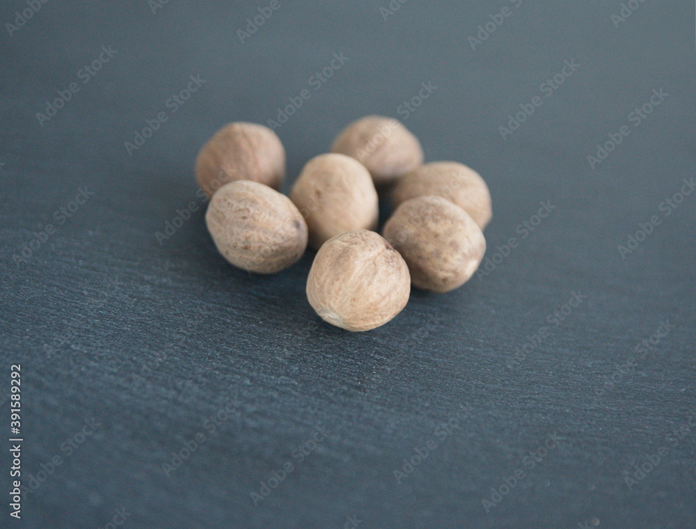 Nutmeg , muscat nut, Myristica fragrans nut, culinary spice on grey ...