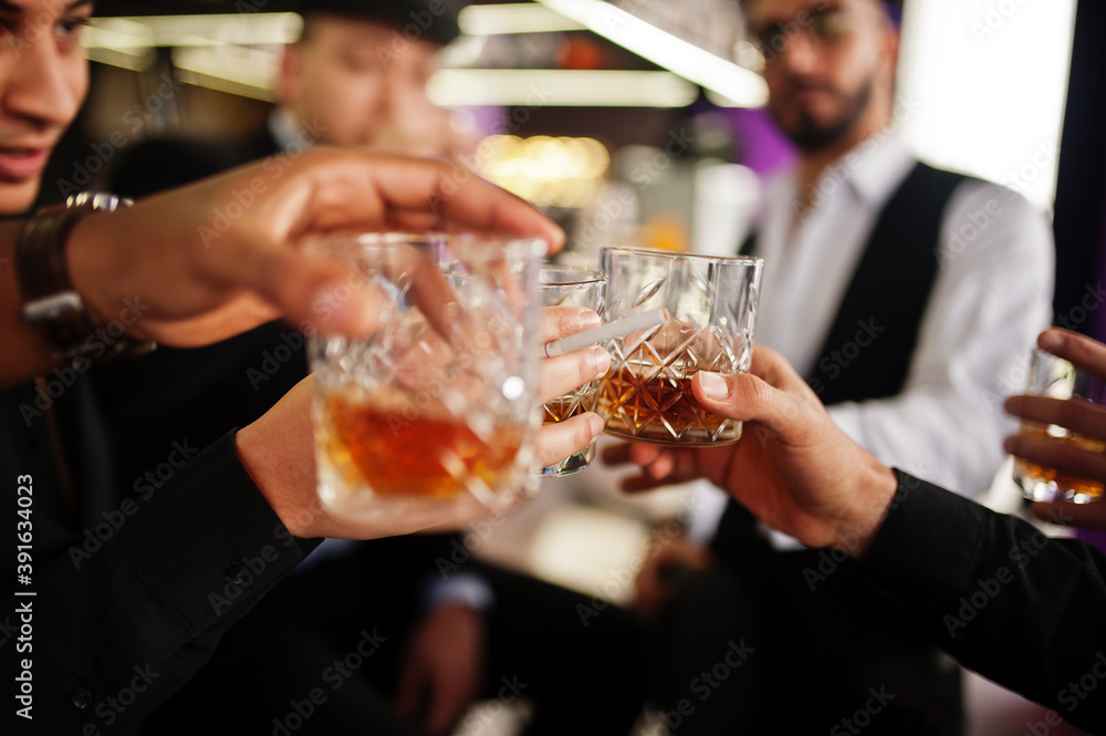 Cheers! Group of handsome retro well-dressed man gangsters spend time ...