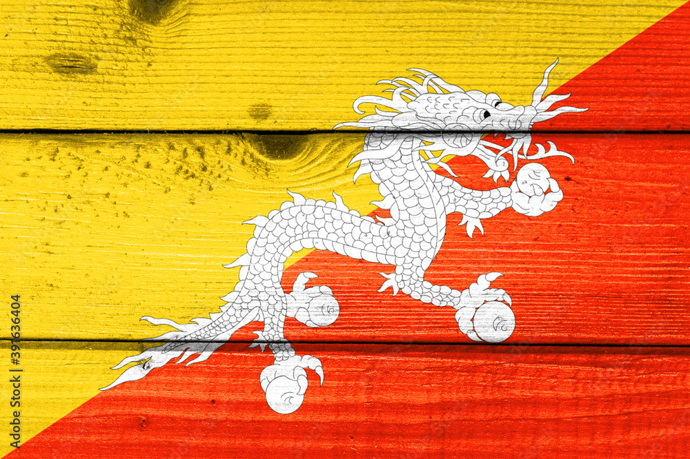 Bhutan flag painted on old wood plank background. Brushed natural light ...