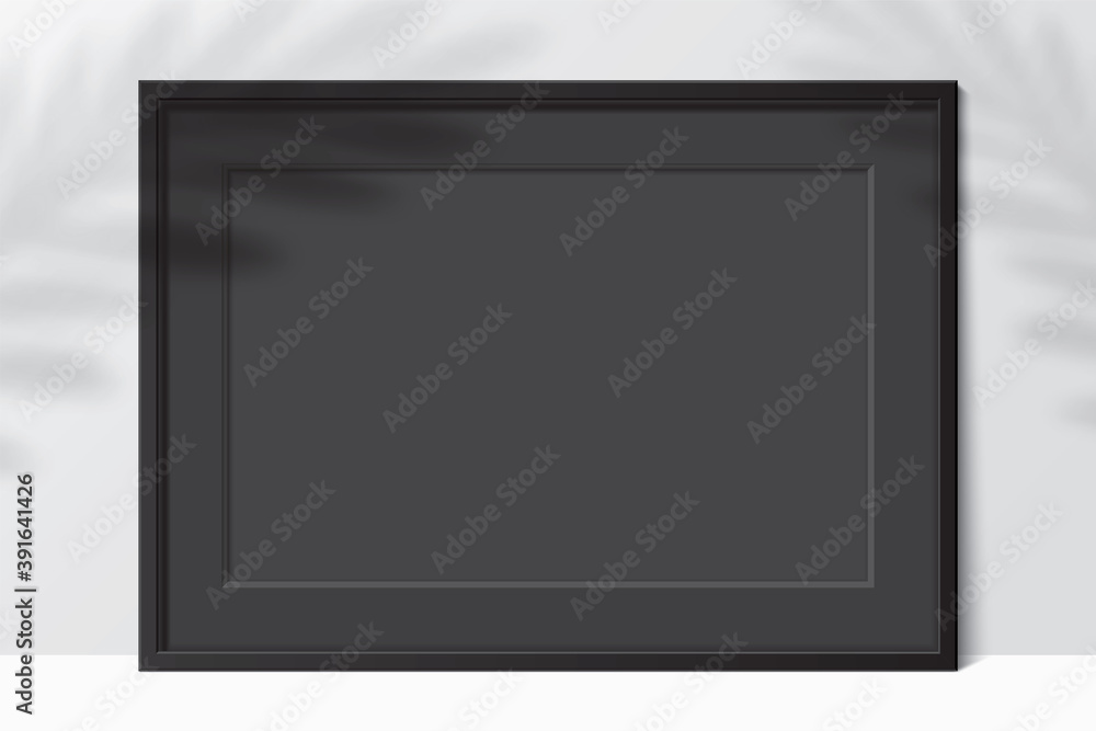 Black horizontal frame, standing on a white background with leaf ...