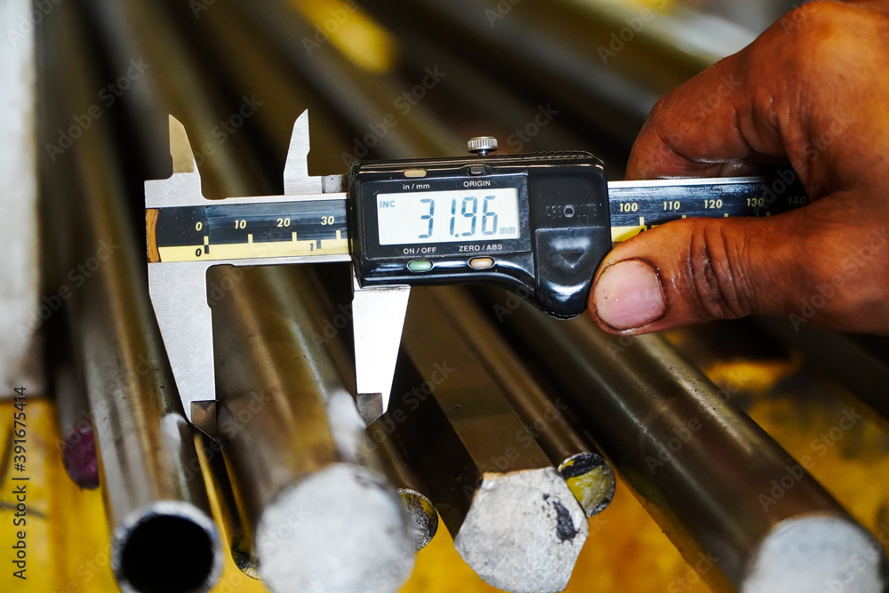Hands of engineers measuring rebar, round shaft, Vernier caliper ...