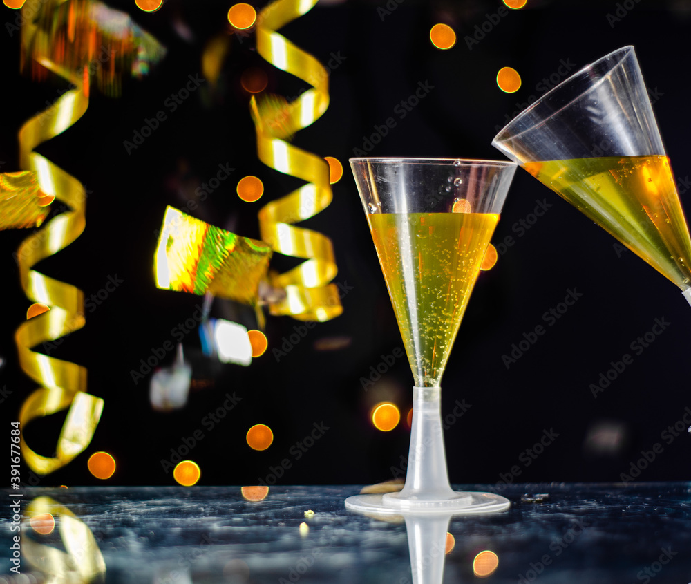 toast with champagne glasses on a black background with yellow bokeh ...