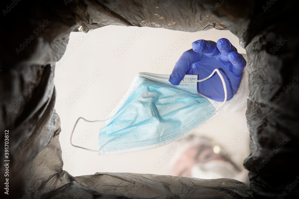 Face mask after use. Environmental pollution by medical waste. Throwing ...