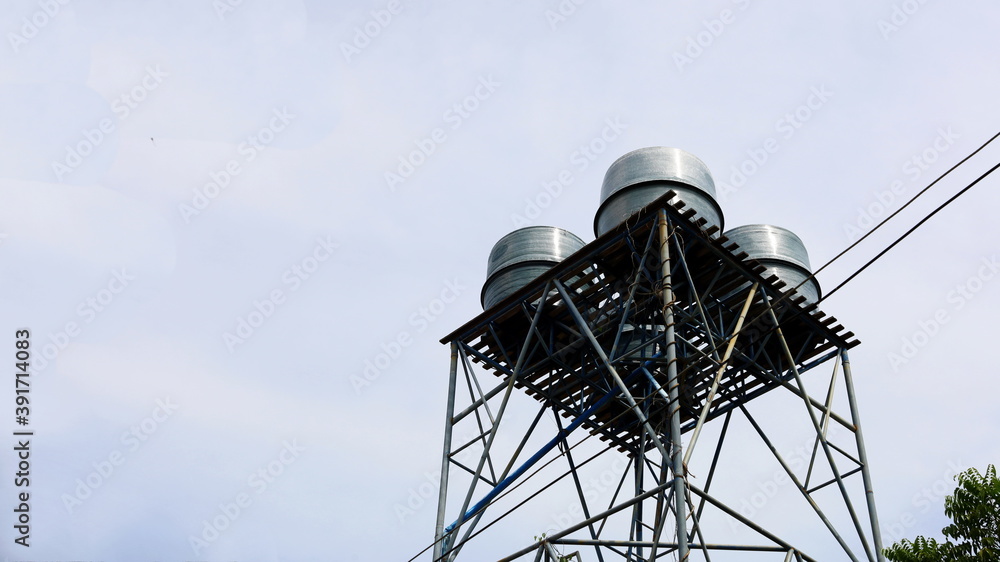 Fiberglass water tank on the tower. Four outdoor storage tanks with ...