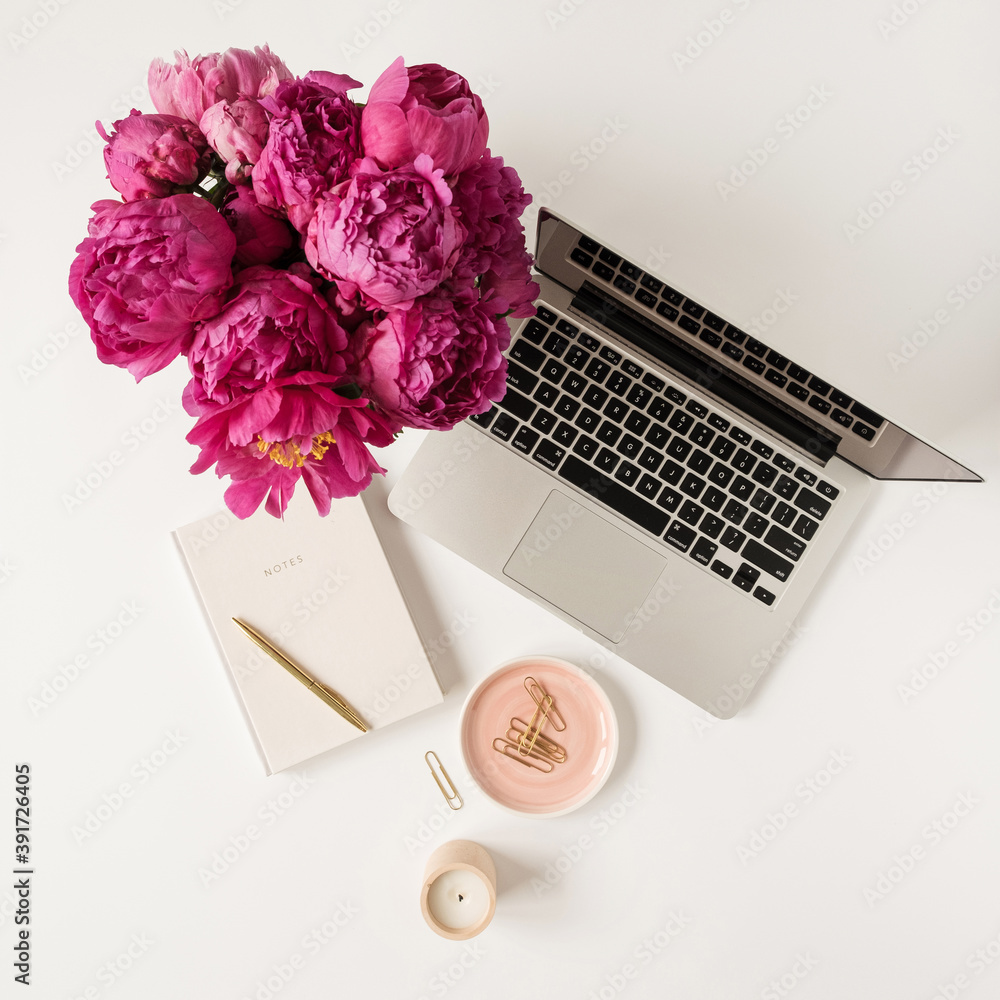 Laptop, beautiful pink peony tulip flowers bouquet and notebook on ...