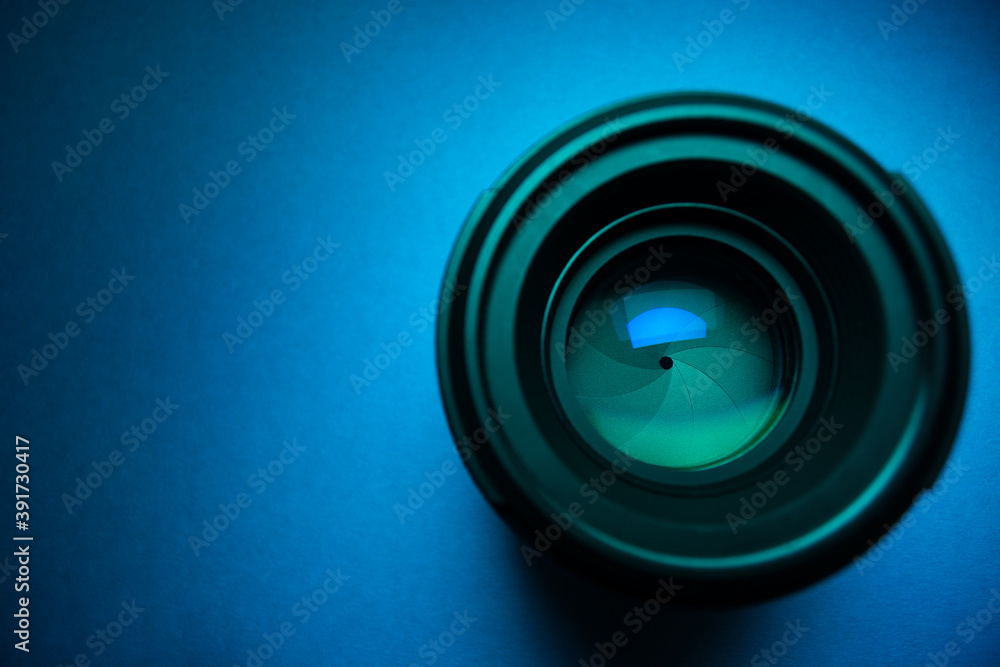 Close up camera lens reflection under light blue neon light with ...