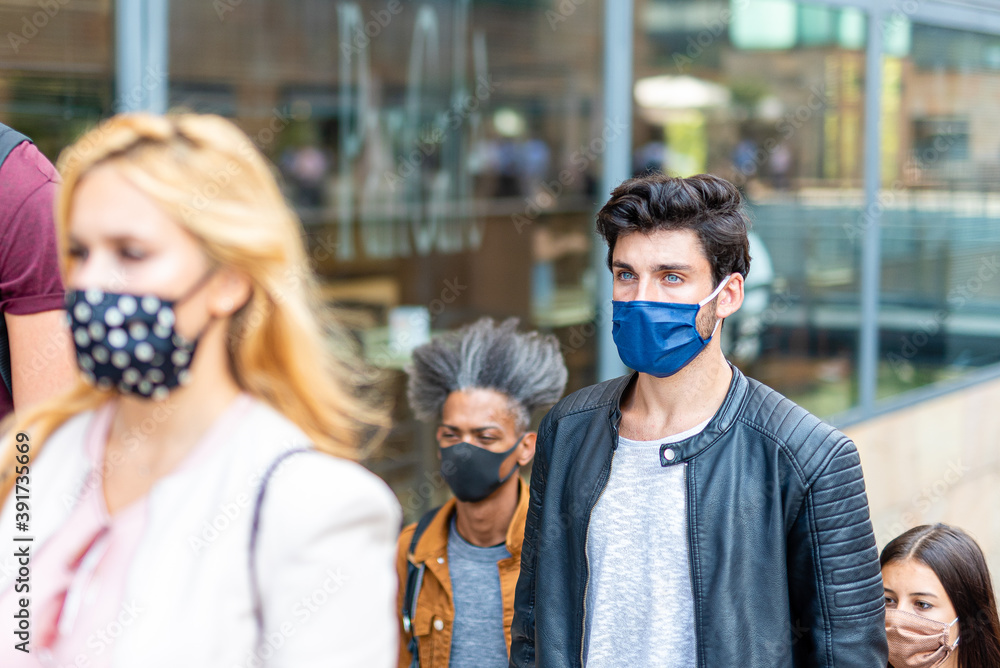 multi-ethnic urban crowd of young people walking the streets, wearing a ...
