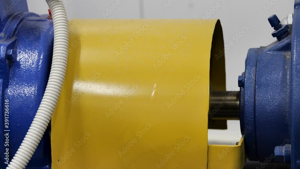 Close up of rotating element of the engine colored in blue and yellow ...