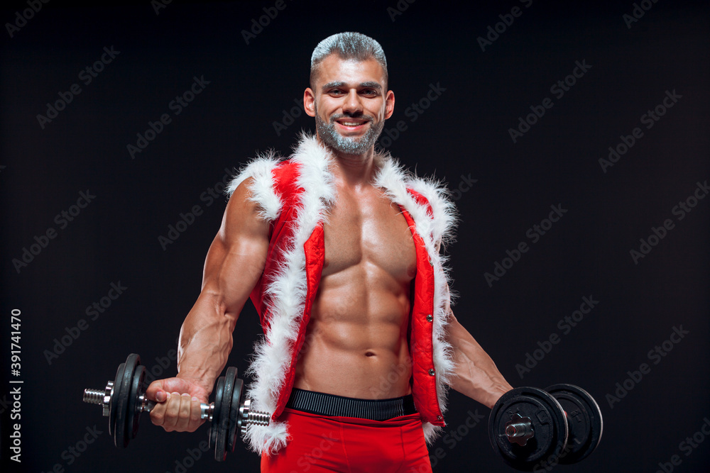 Sexy Santa Claus. Bodybuilder young handsome santa clause smile holds a ...