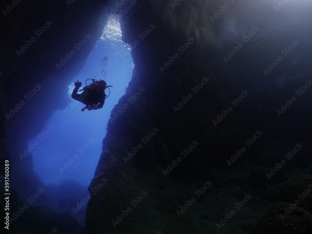 scuba divers enjoying the topography and fauna underwater ocean scenery ...