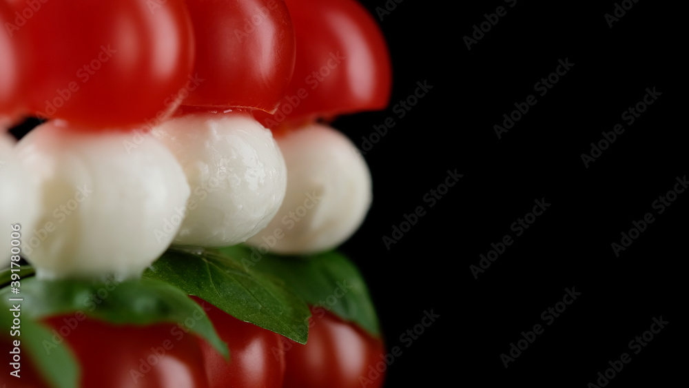 caprese salad as canapes on black background. Italian salad Caprese ...
