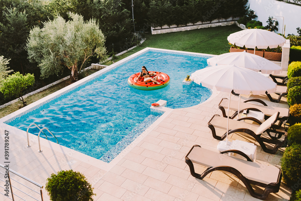 Sexy Woman Relax In Swimming Pool Laying On Inflatable Watermelon Pool