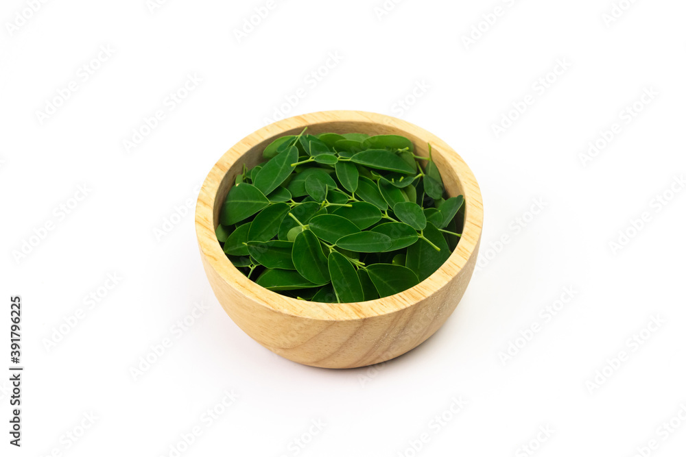 Moringa leaf on wooden bowl isolated on white background. Moringa ...