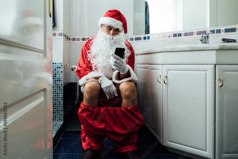 Santa Claus in the bathroom, sitting on the toilet pooping and looking ...