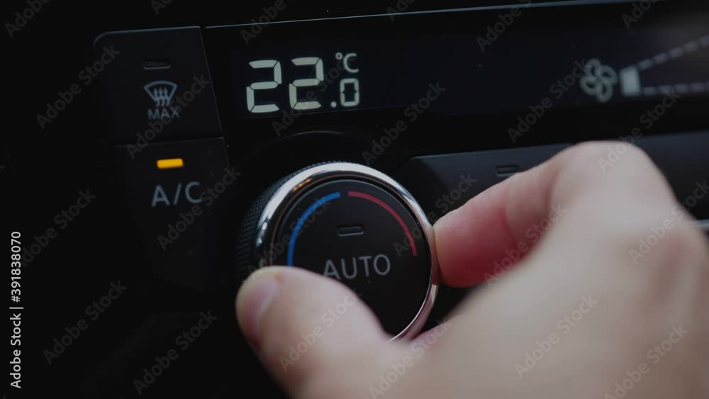 set up air conditioner in the car. Hand turns air conditioner ring ...