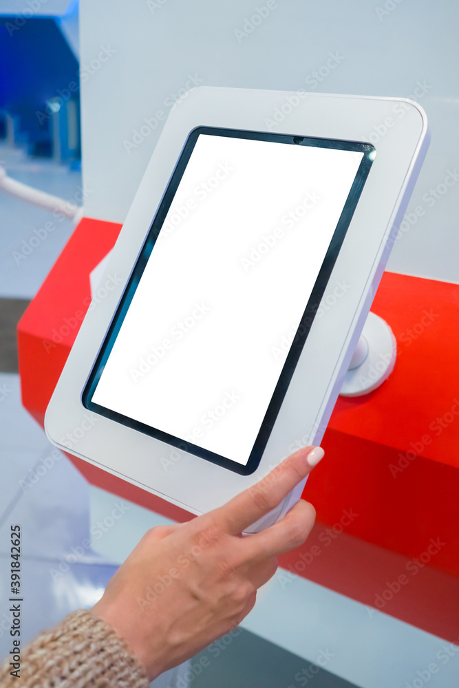Close up - tablet kiosk with blank vertical white display at exhibition ...