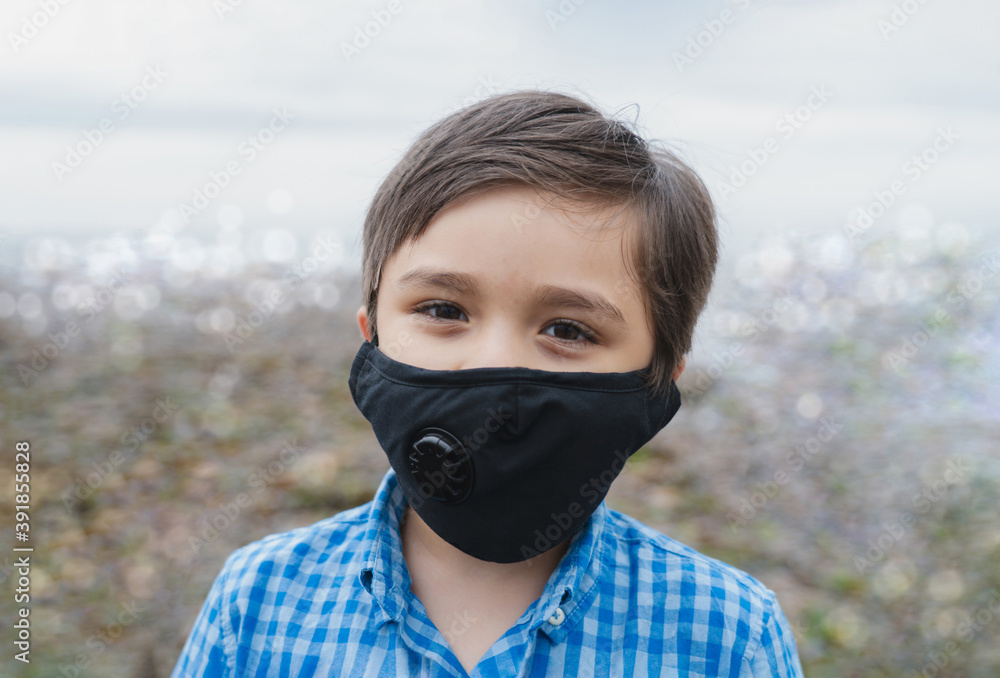 Kid wearing protective face mask for pollution or virus, Mixed race ...