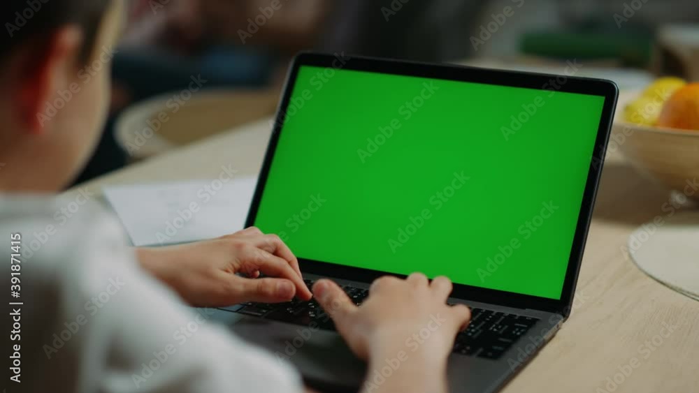 Boy surfing internet green screen laptop. Student typing keyboard ...