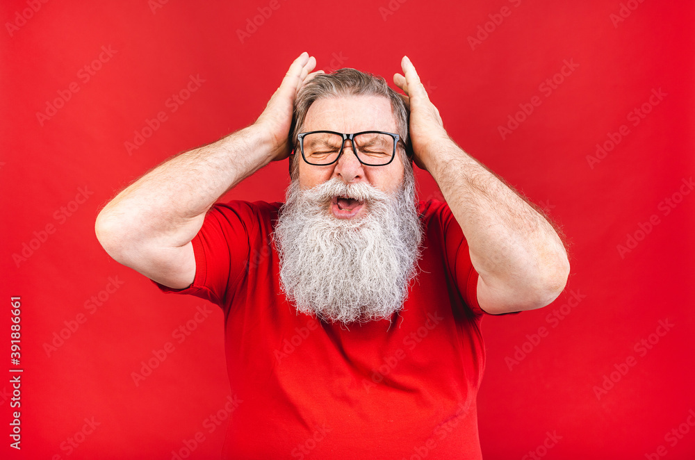 Senior aged grey-haired man standing over isolated red background angry ...