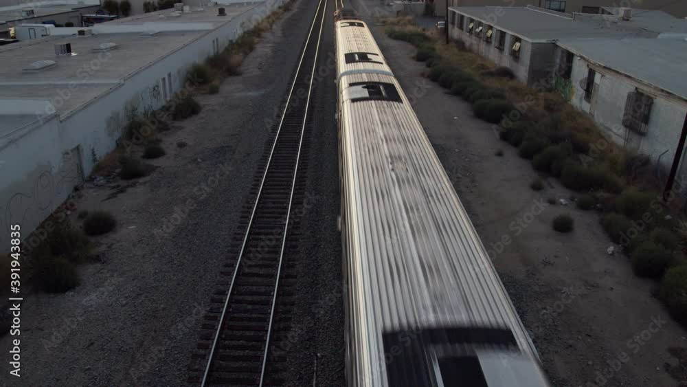 Train passing from underneath as camera sweeps up into cinematic sunset ...
