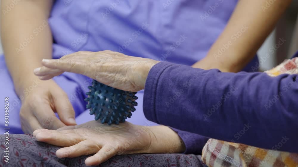 Elderly woman doing rubber ball for exercise fingers, palm ,hand and ...