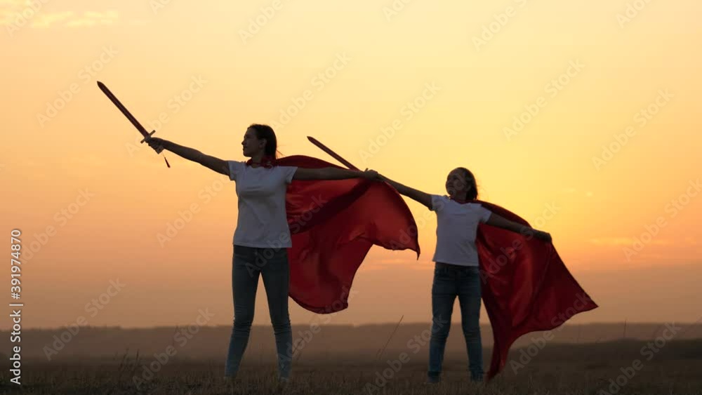 children play spartans. girls in red cloaks run with swords in hand ...