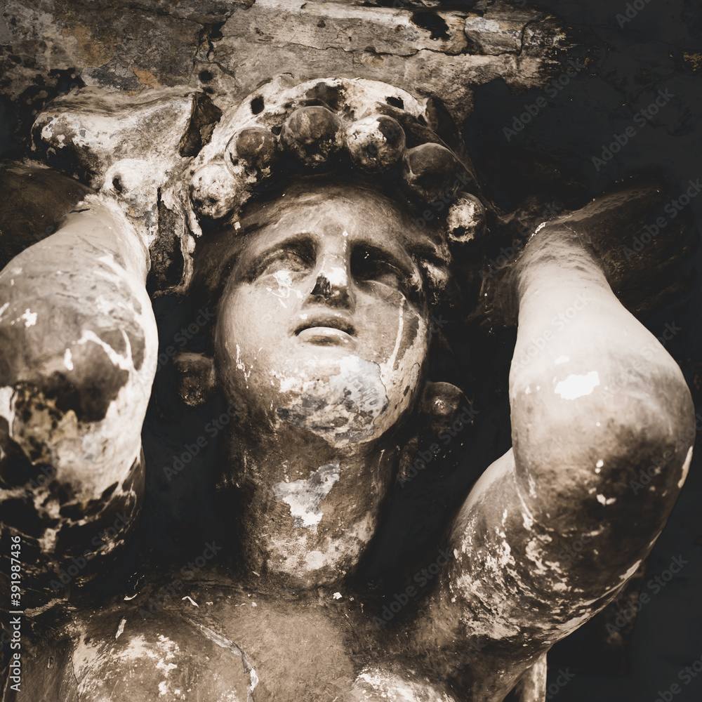 Ancient statue of Sisyphus rolling very big stone to top of high ...