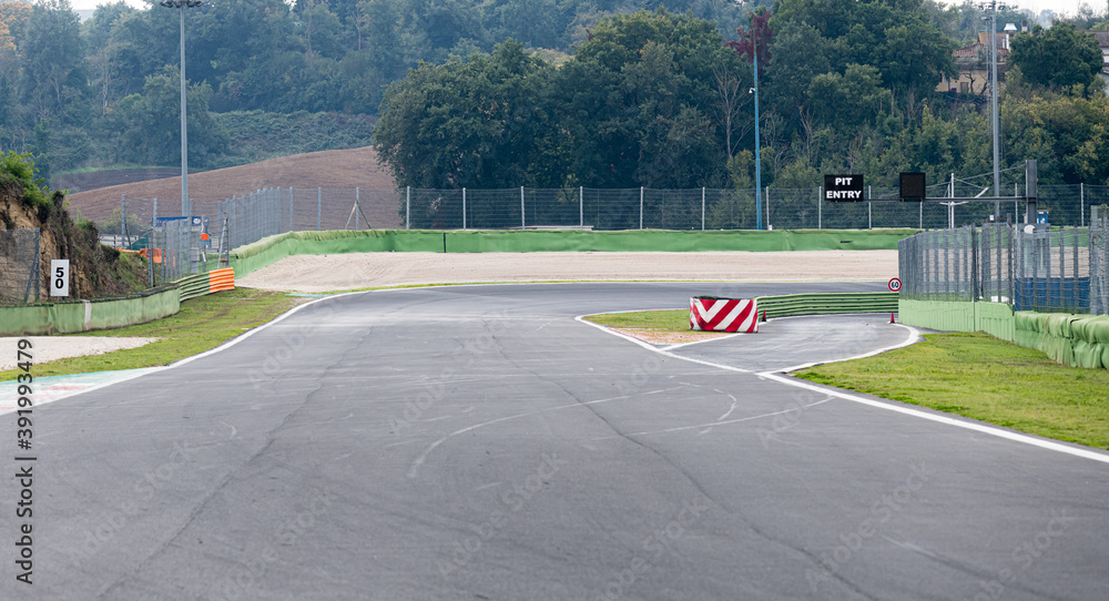 Separation obstacle warning and pit lane entry text board on asphalt ...
