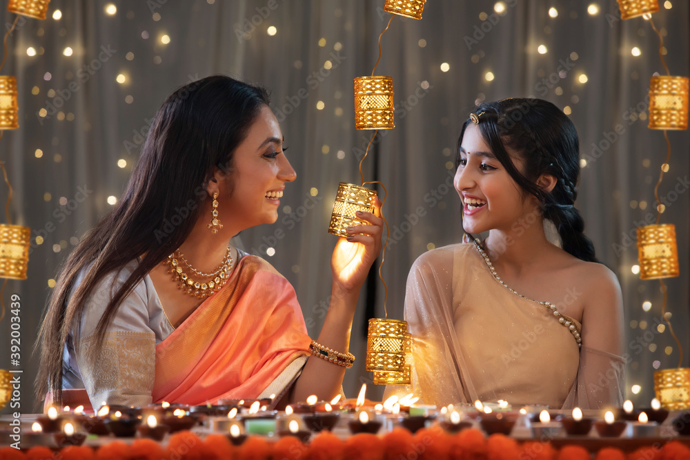 Mother and daughter adoring lights together Stock Photo | Adobe Stock