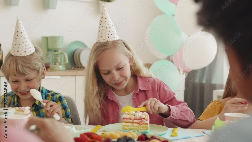 Over shoulder of unrecognizable kids sitting in front of school girls ...