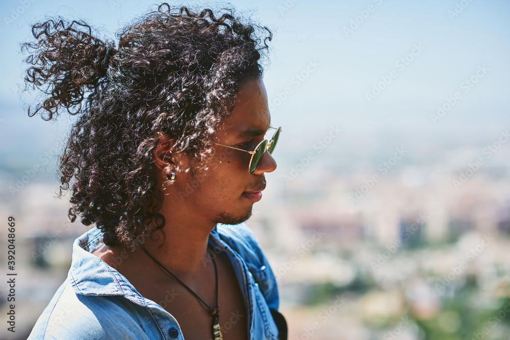 Portrait of young attractive man with dark skin. He is a musician from ...