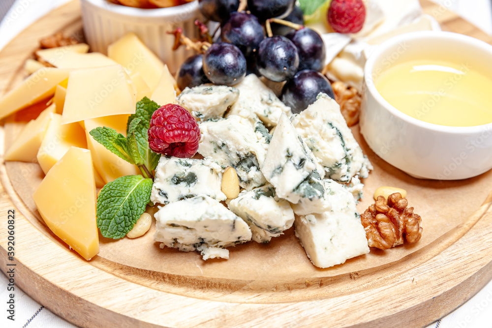 Board with different types of cheese. Cheeses mix set dor blu chedar ...