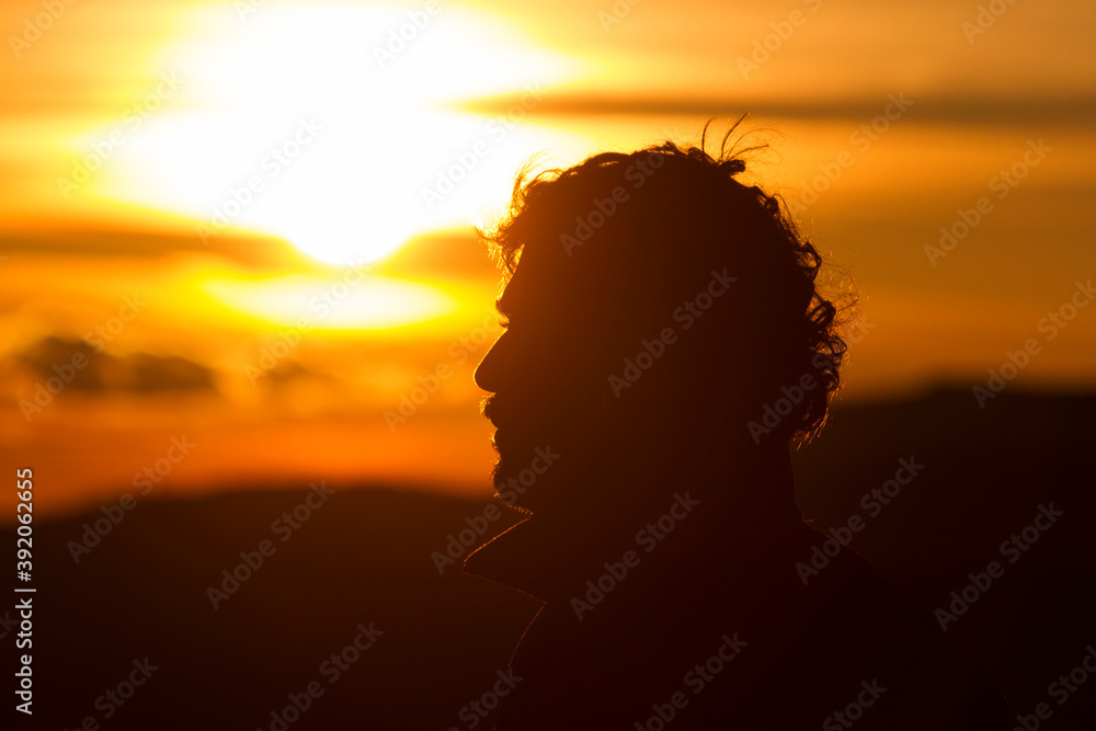 Silhouette of a man's head at sunset Stock Photo | Adobe Stock