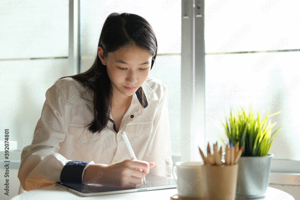 Young student girl using degital pen write on tablet. Stock Photo ...
