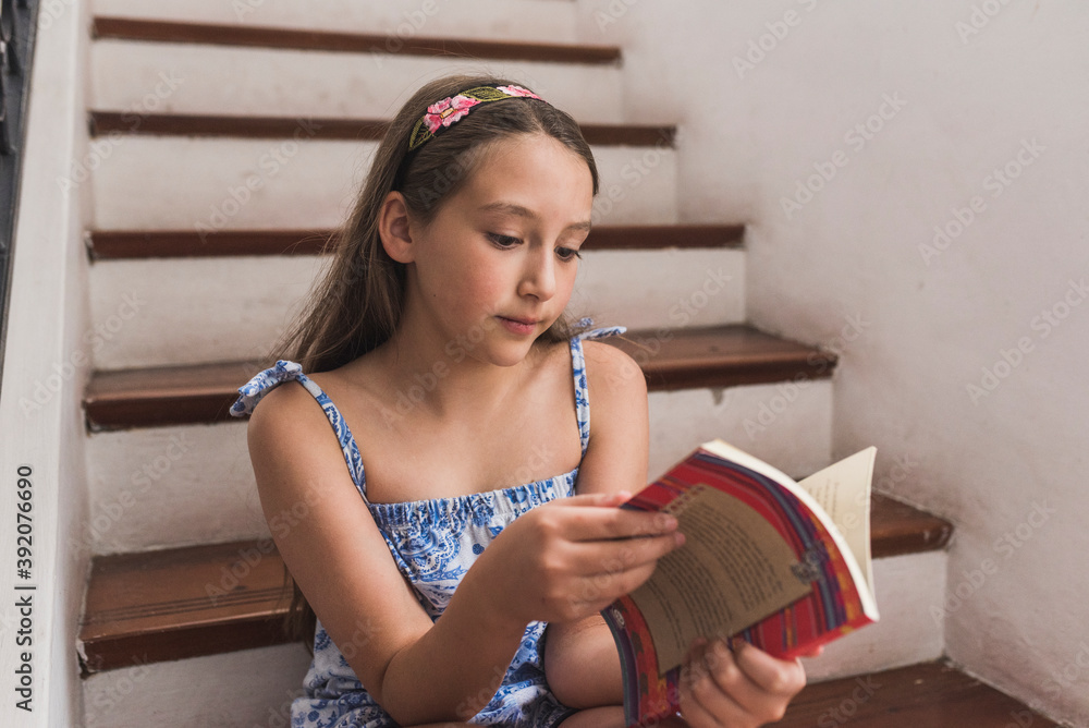 Cute little girl reading a story Stock Photo | Adobe Stock