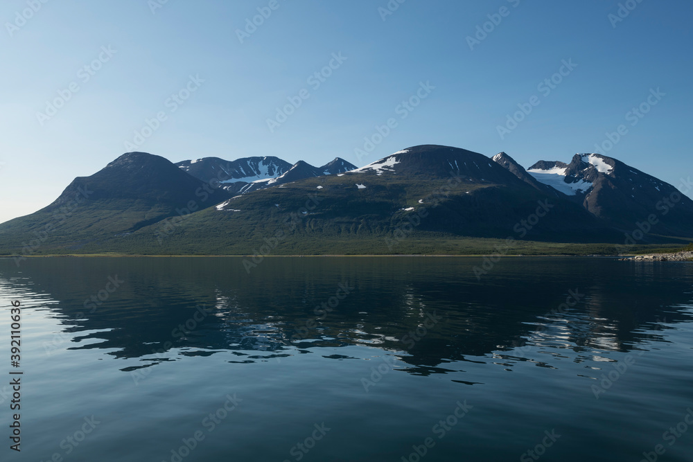 Reflection of mt. Ahkka massif from lake Akkajaure, Lapland, Sweden ...