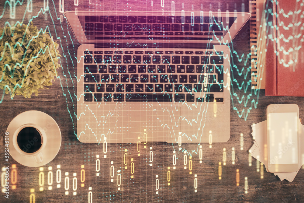 Stock market chart and top view computer on the table background. Multi ...