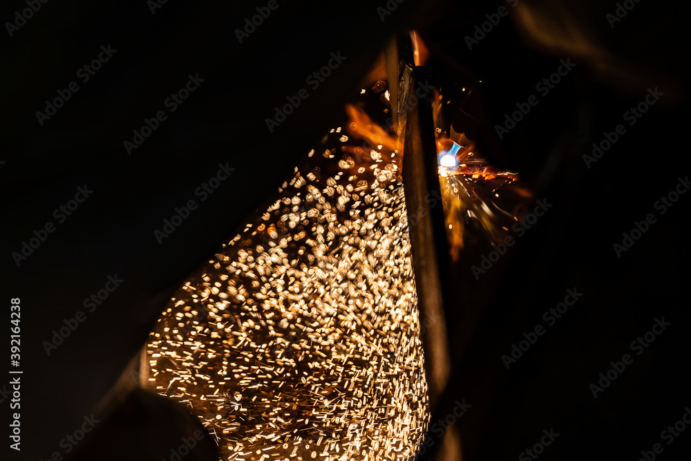 Plasma cutting of metal in production close-up, a blue flame under ...