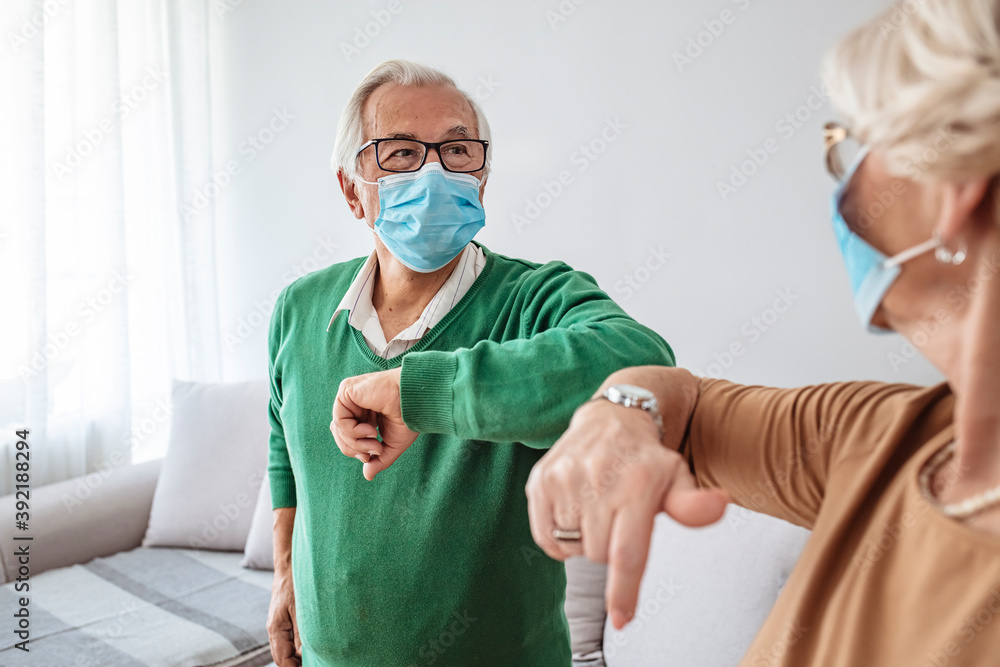 Friendly smiling senior friends keeping social distance, greeting each ...