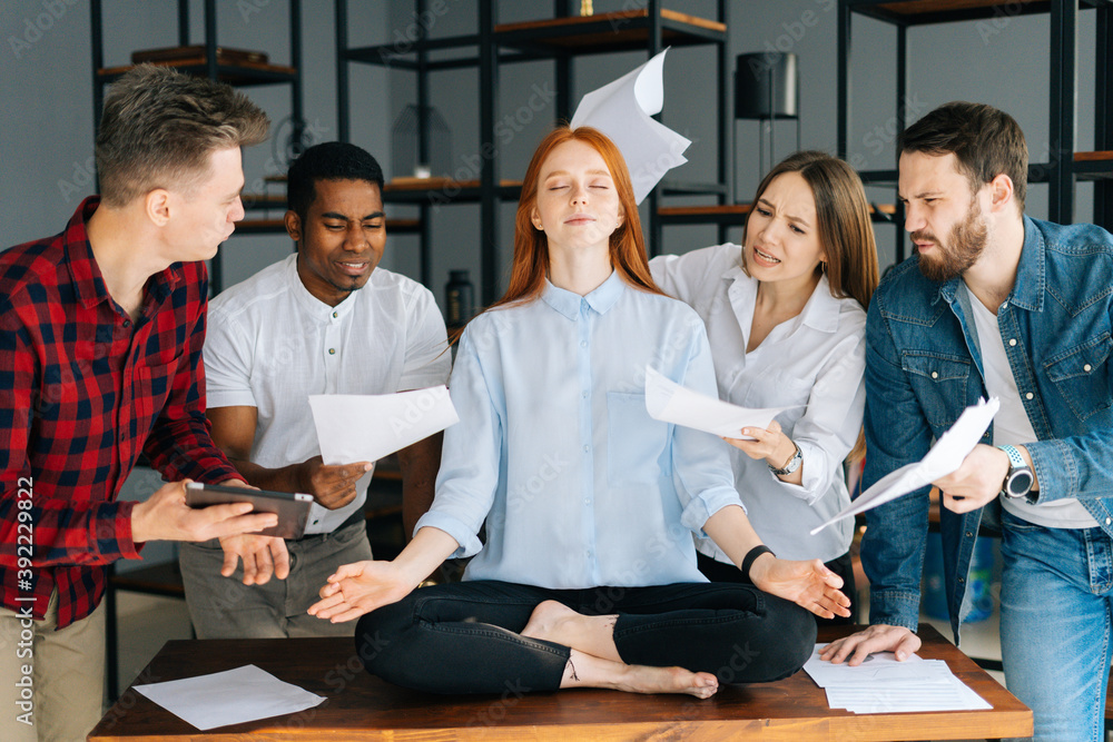 Portrait of calm young business woman meditate at business meeting ...